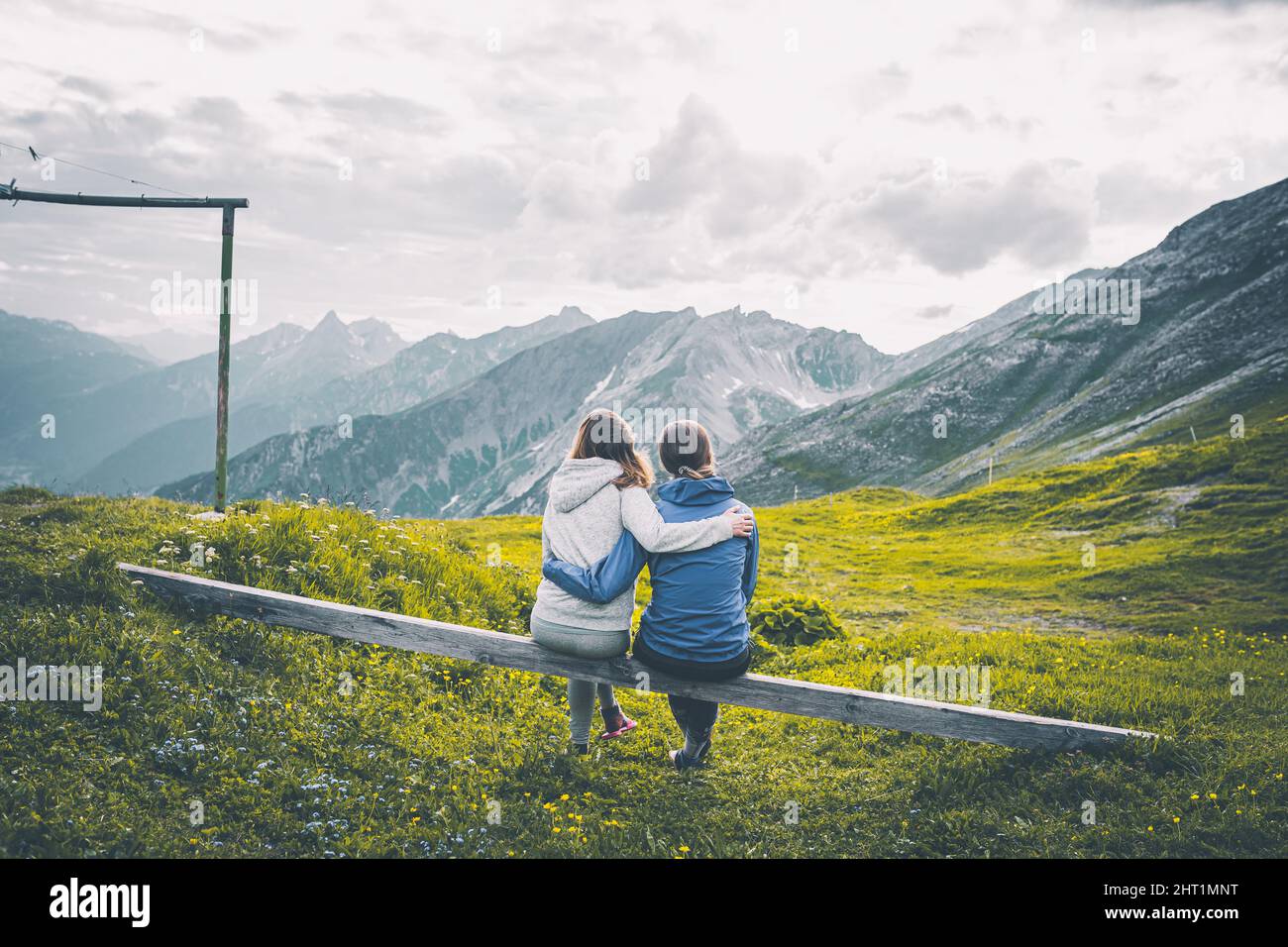 Beautiful shot of a couple in green alps Stock Photo - Alamy