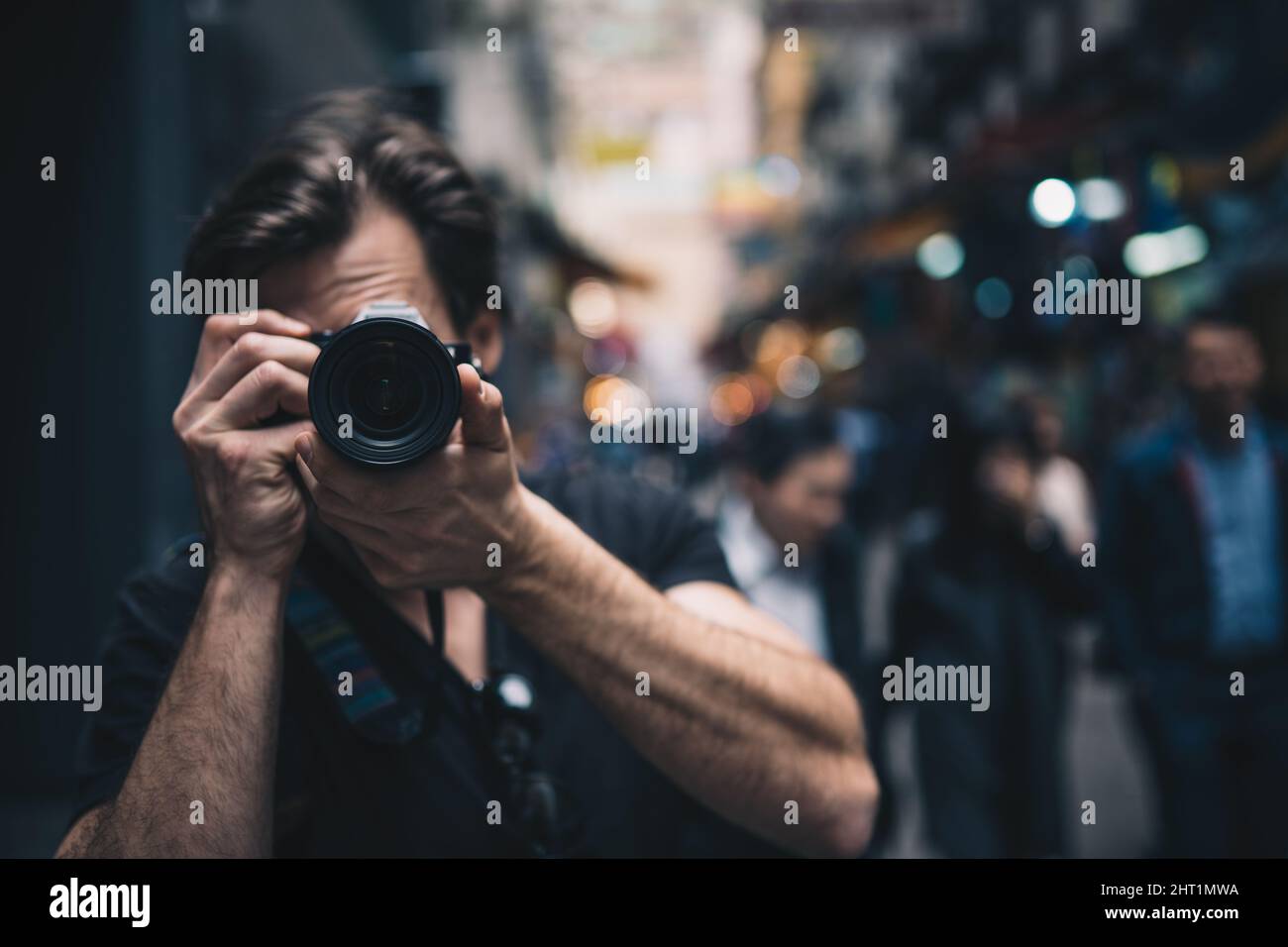 Shallow focus of a professional male photographer with a camera in his ...
