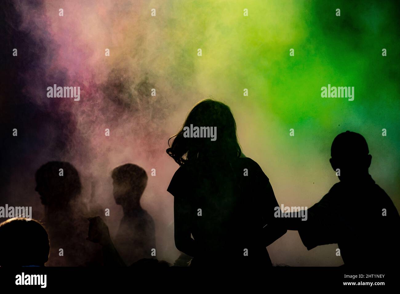 Silhouette of dancing people in Color festival event Stock Photo - Alamy