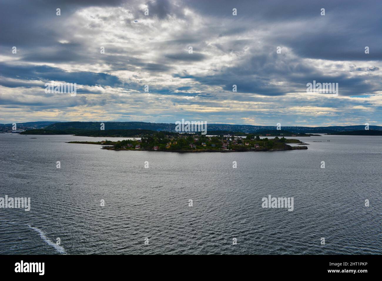 Bird's eye view of an island covered with greenery and buildings ...