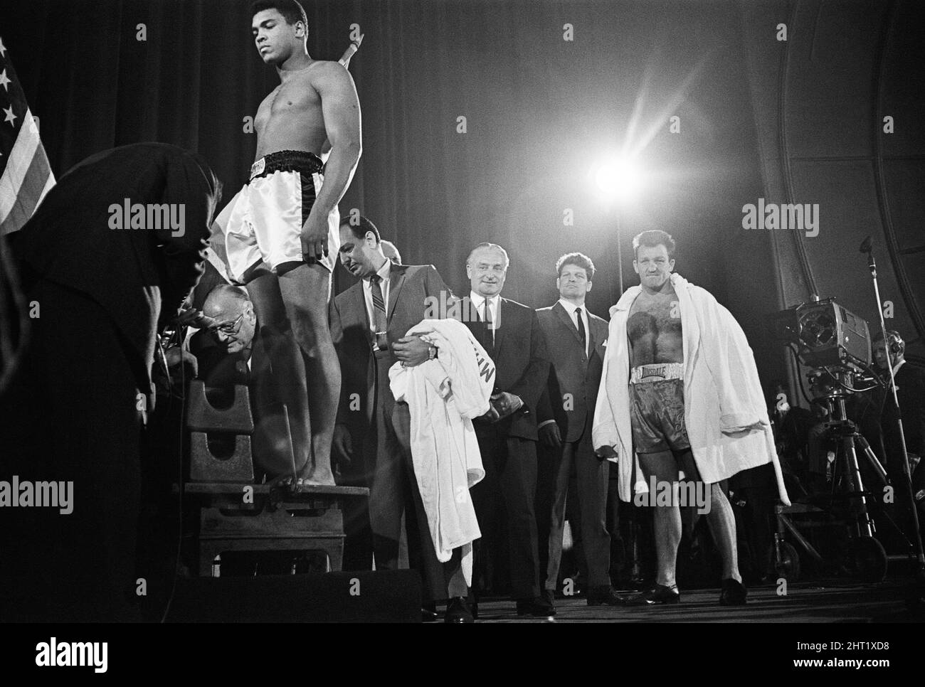 Muhammad Ali stands on the scales as Brian London looks on at the weigh ...