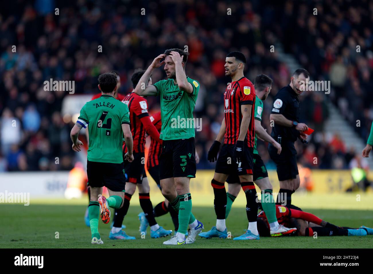 Stoke City's Morgan Fox is shown a red card by referee Tim Robinson ...