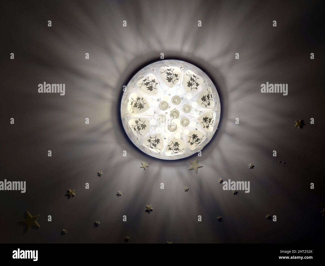 Low angle shot of decorative bright light with glow in the dark stars ...