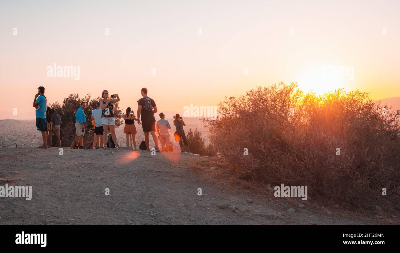 Relaxing at Filopappou Hill enjoying the view of Acropolis Hill with ...