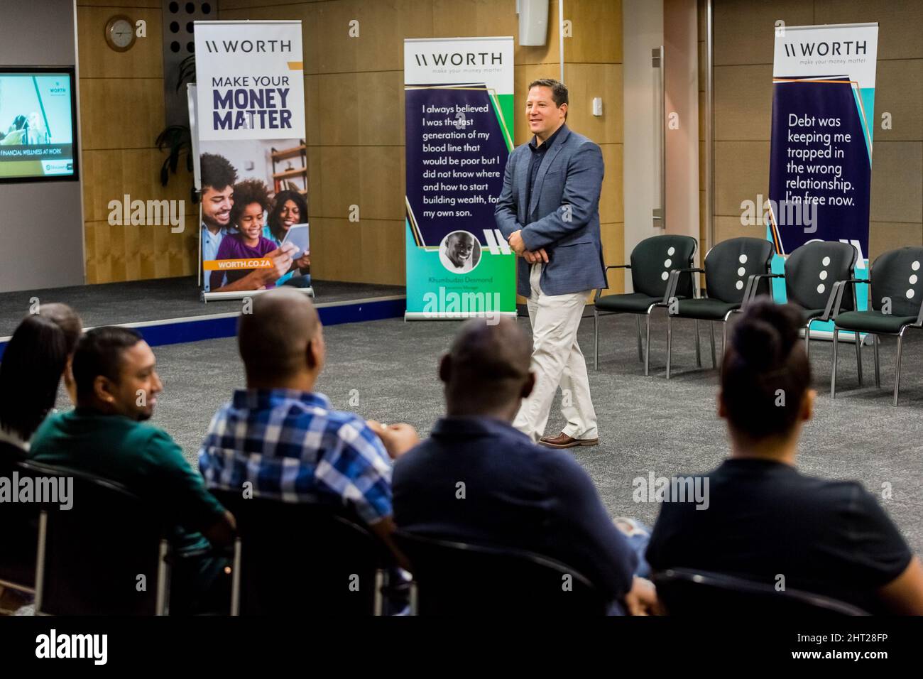 Educator instructing diverse adult students on personal finance Stock ...