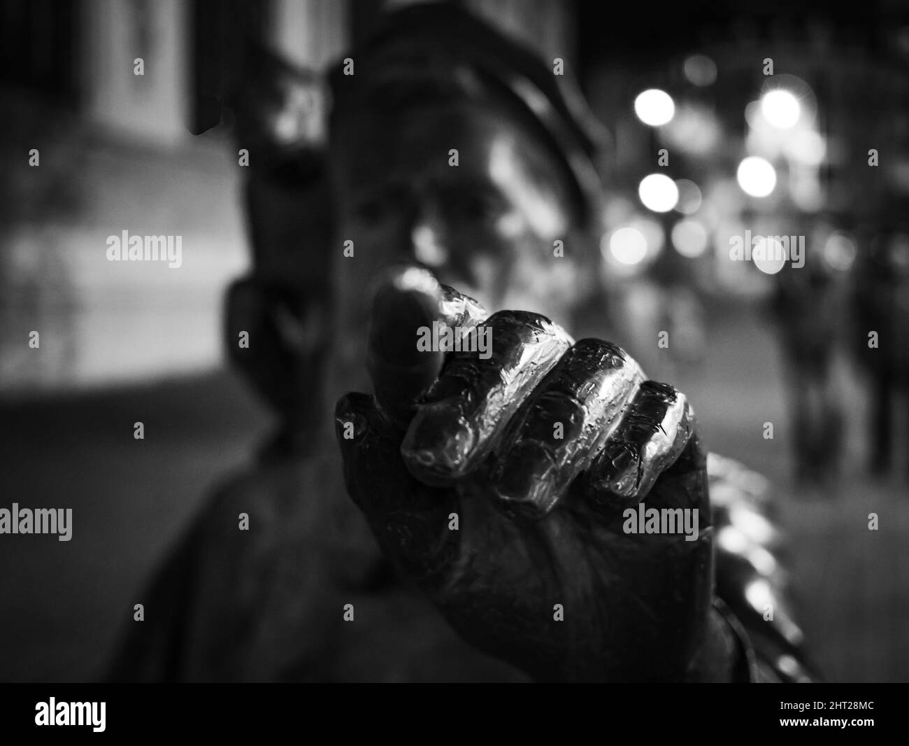 Shallow focus of a metal statue hand pointing at the camera shot in ...