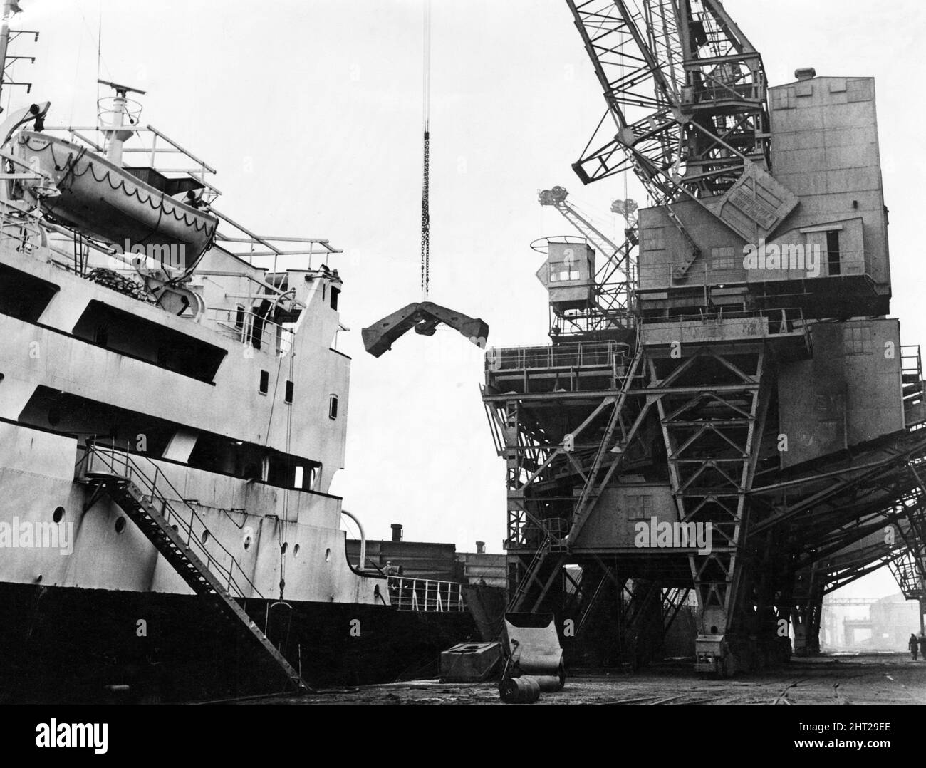 Working at full pressure, another ship is unloaded of it's cargo of ...