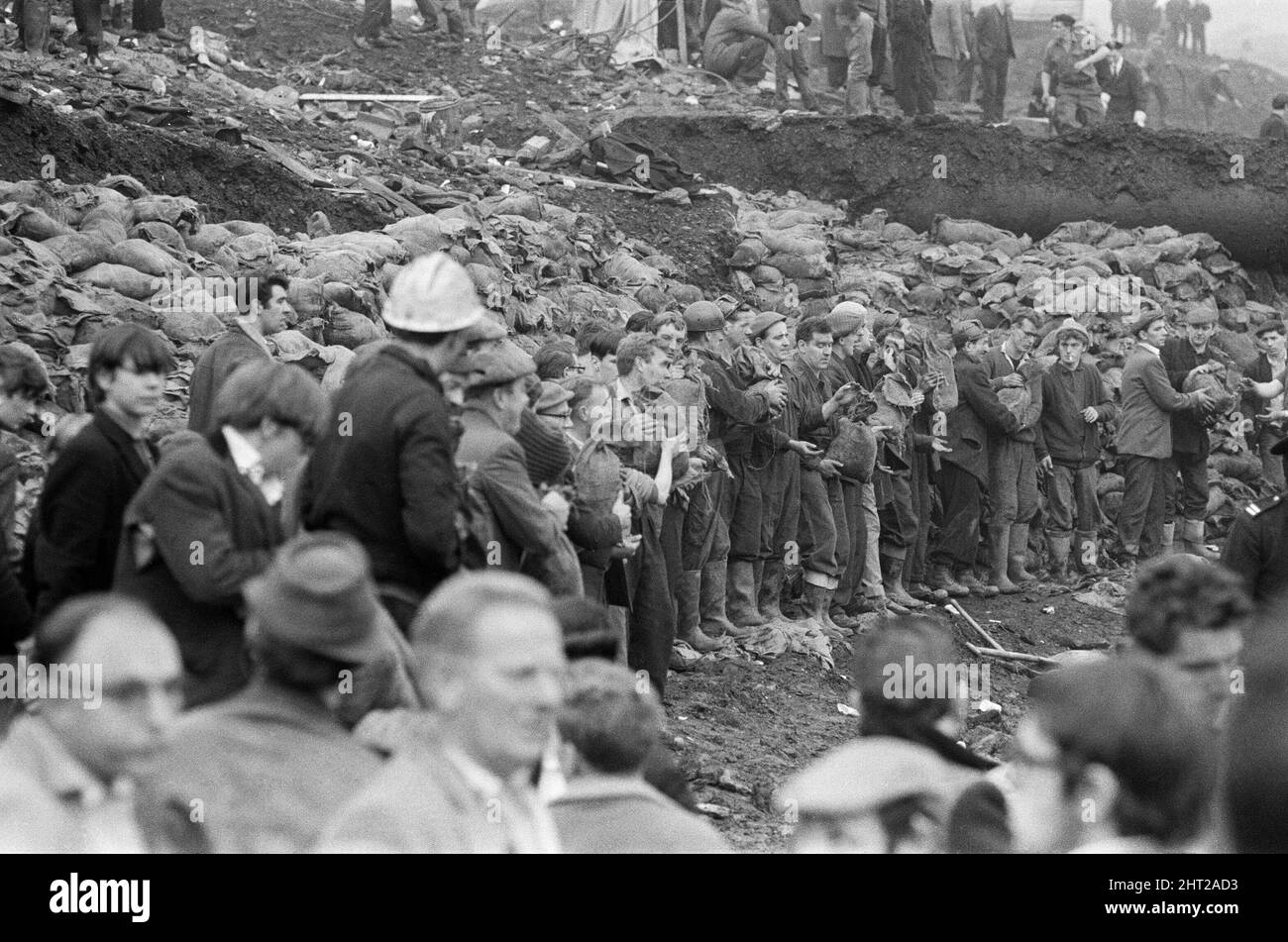 Aberfan - 21st October 1966 Men line up to pass sandbags filled with ...