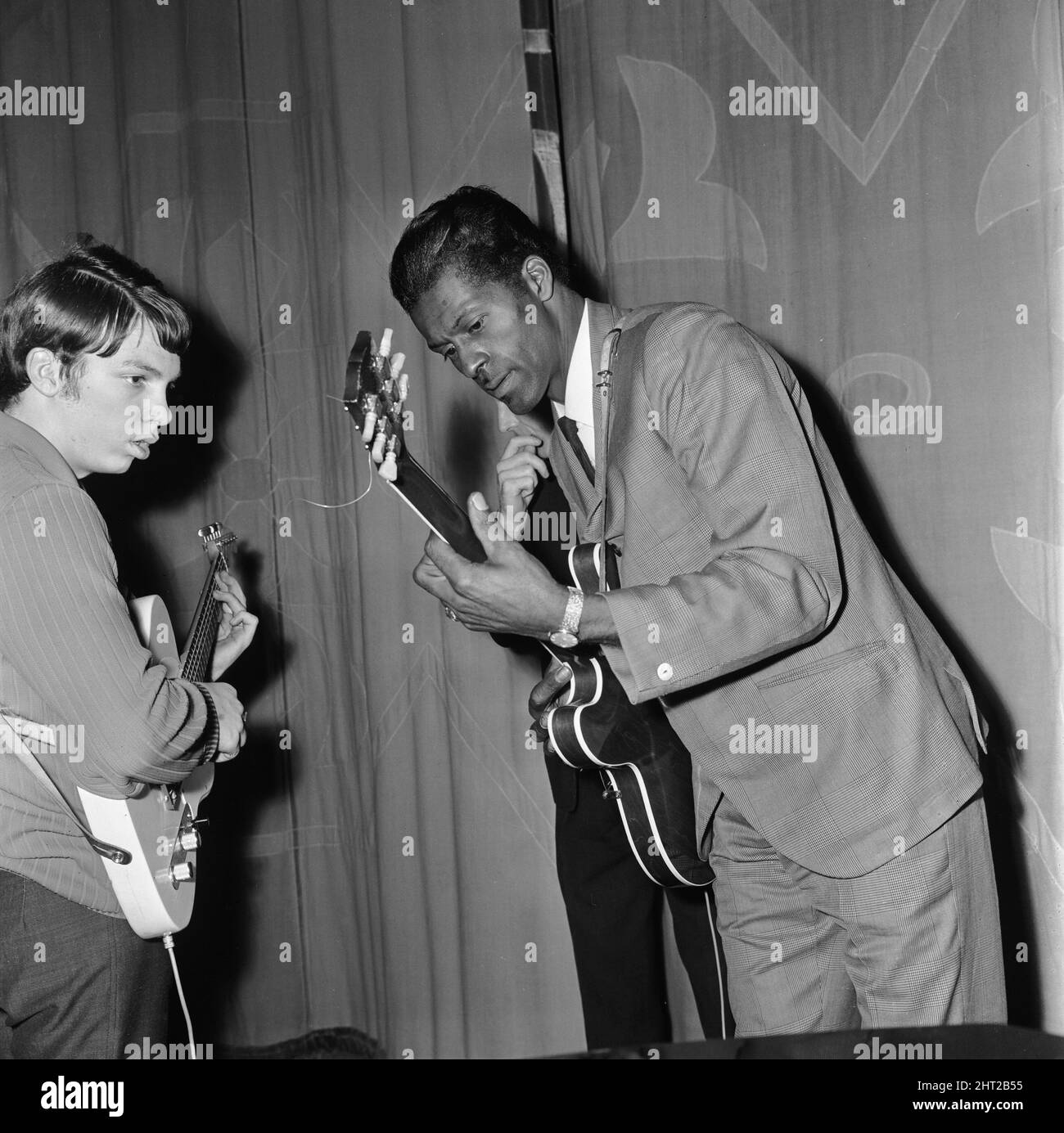American rock and roll singer and musician Chuck Berry tunes up his ...