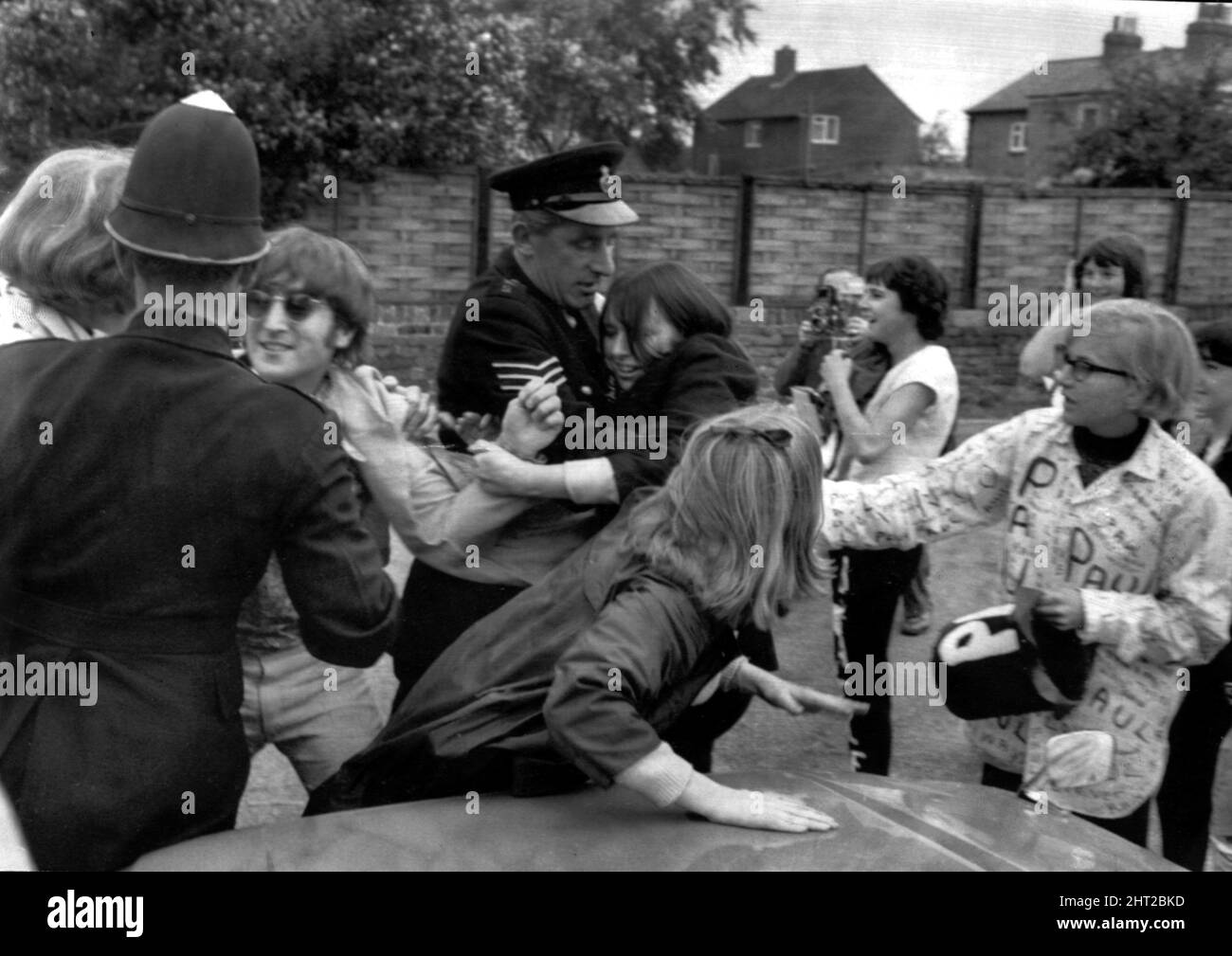 John Lennon of The Beatles being mobbed by fans at London Airport.8th ...