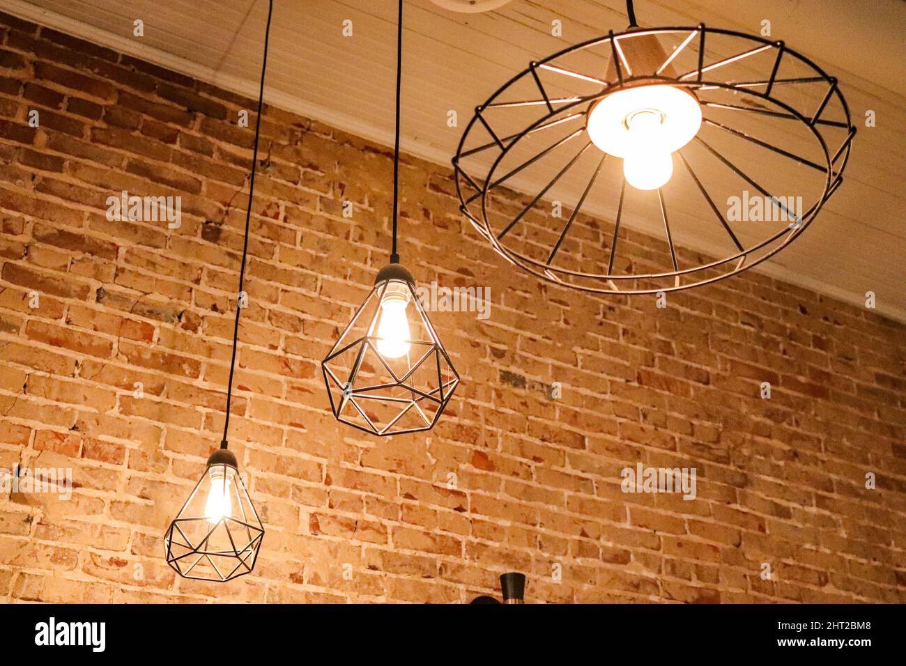 Style lamps hanging on the ceiling on the background of a textured wall ...