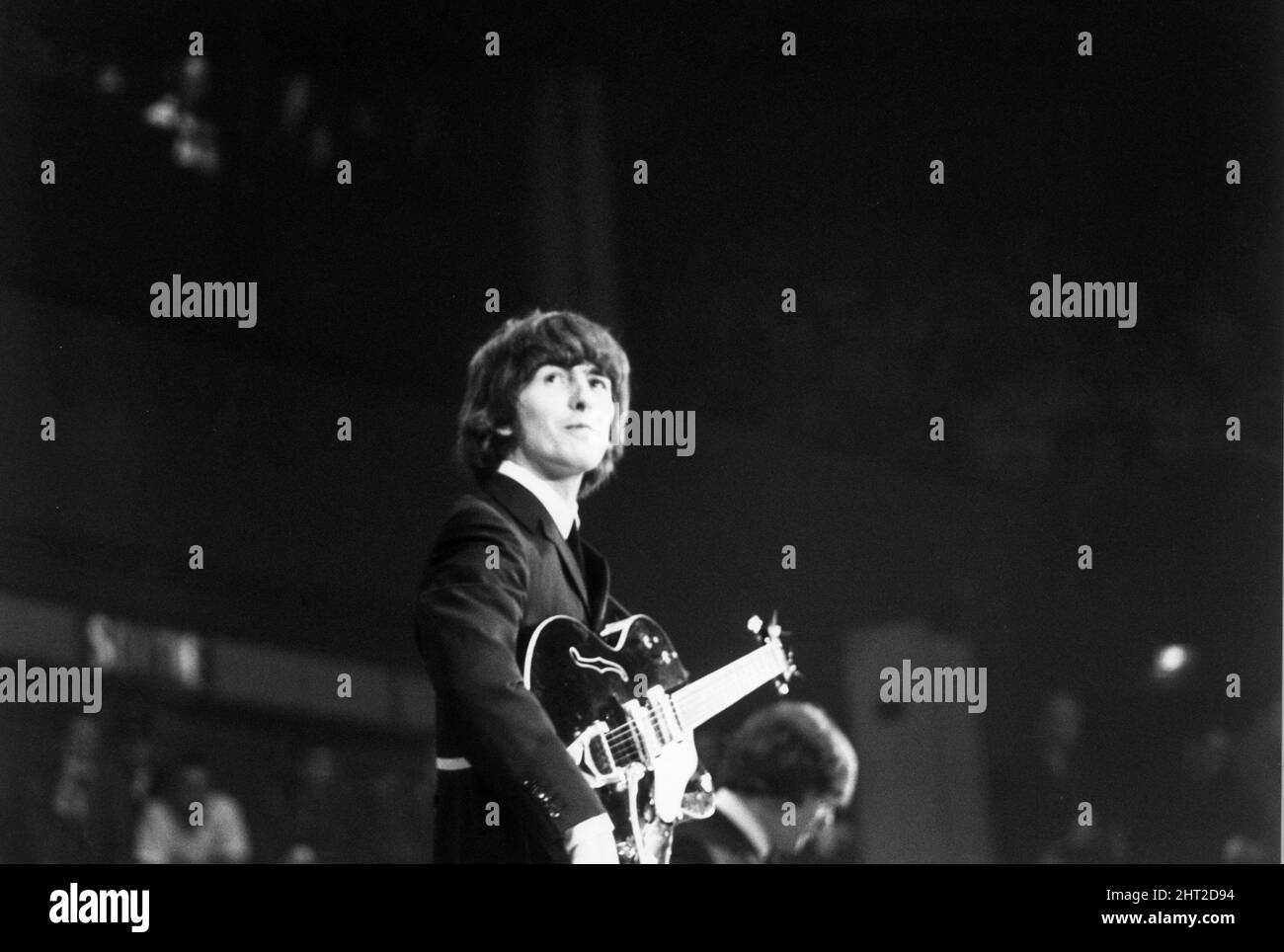 George Harrison of The Beatles on stage at the Palais des Sport in ...