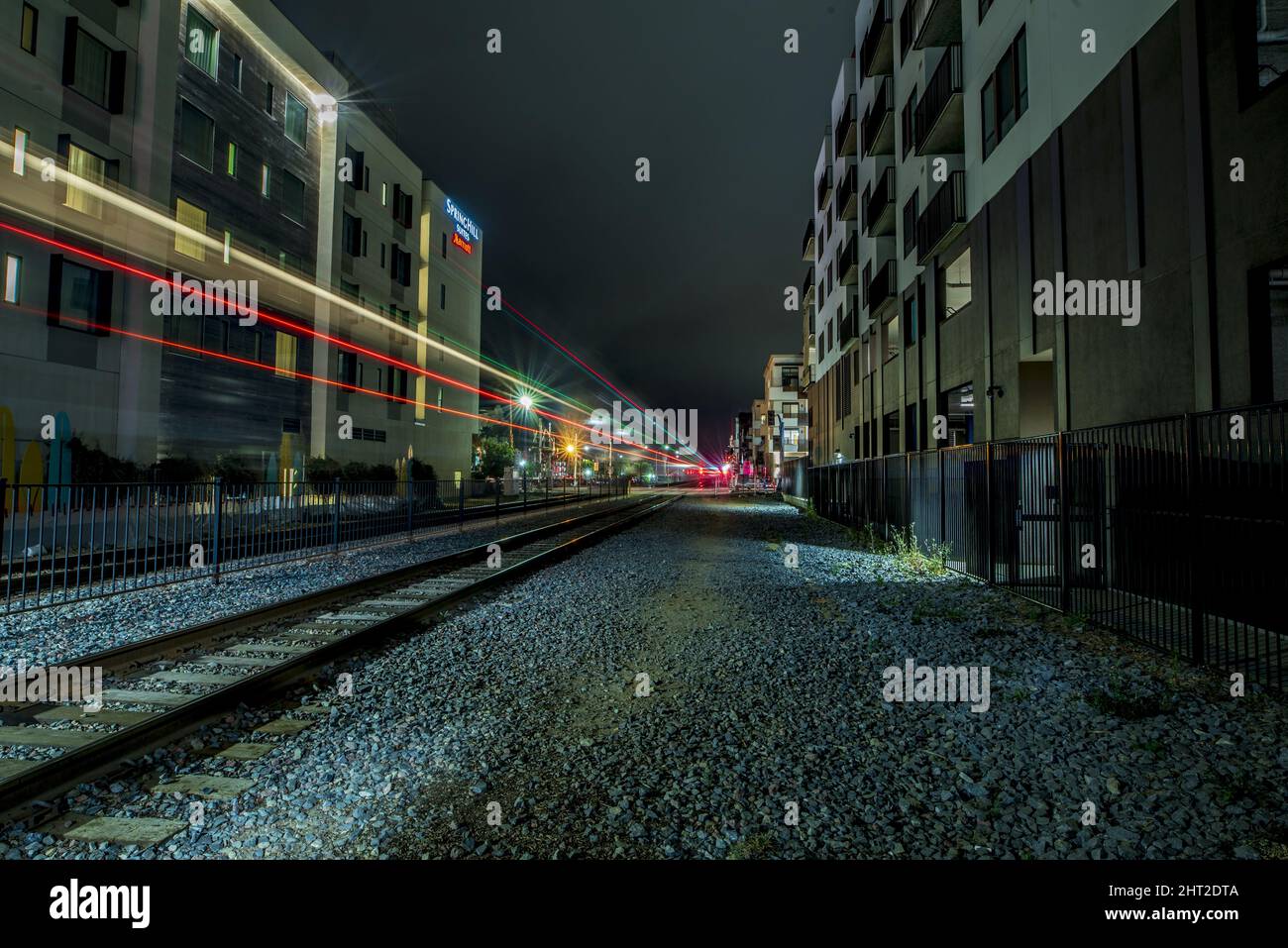 Scenic view of a train railroad surrounded by residential houses Stock ...