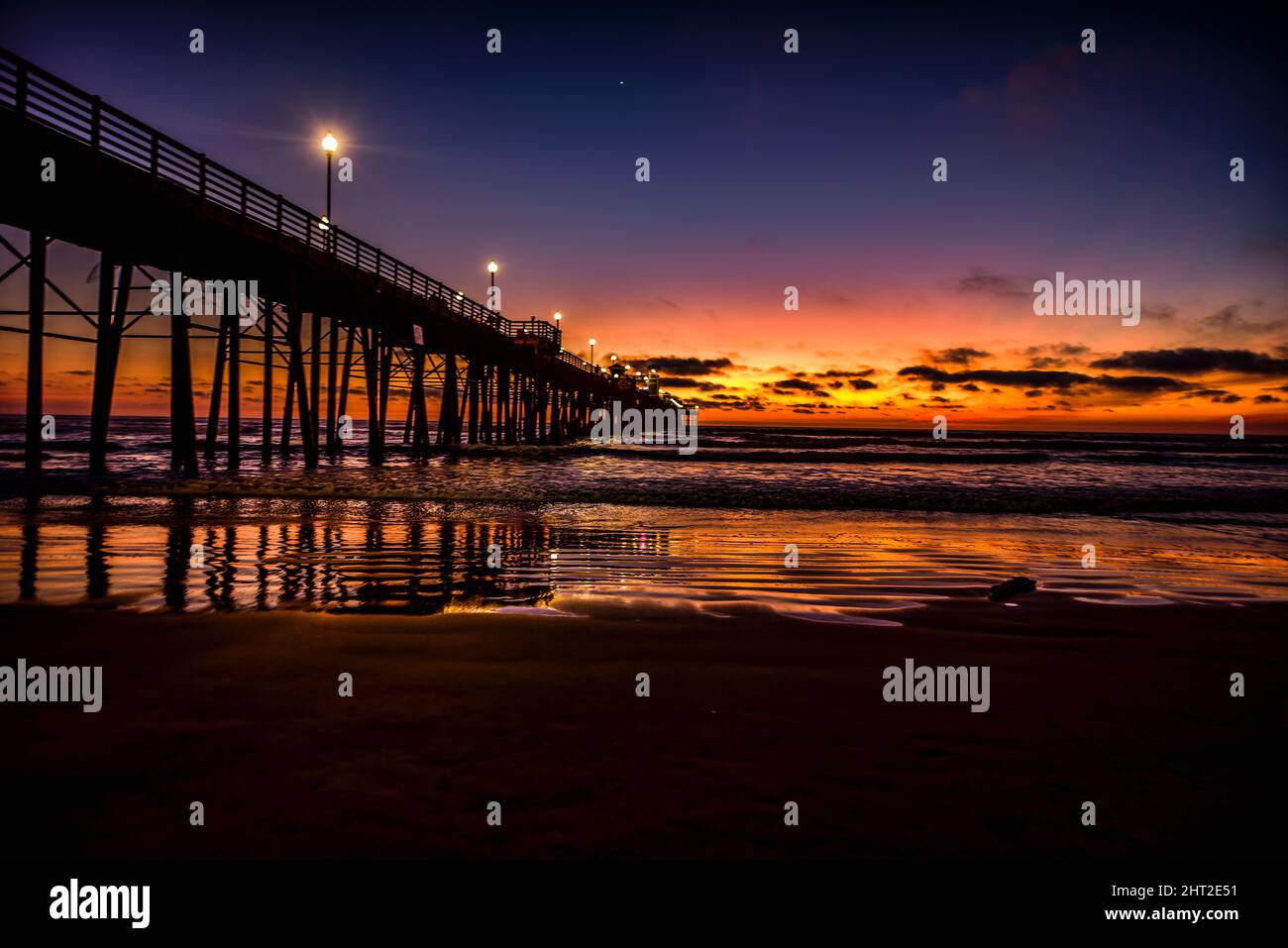 Scenic view of a bridge over the ocean on a bright sunset sky ...