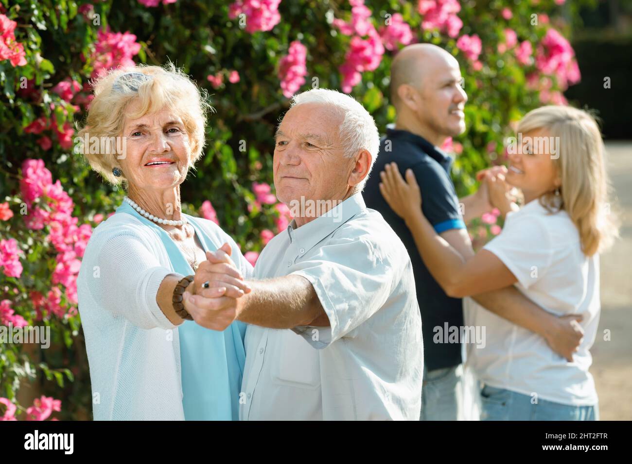 Adult friends dancing pair dance in garden Stock Photo - Alamy