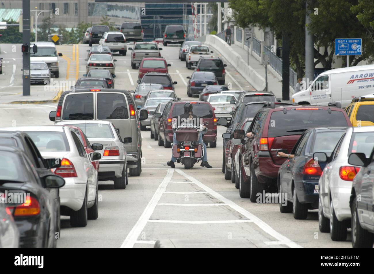Motorcycle in merging traffic in Miami Stock Photo - Alamy