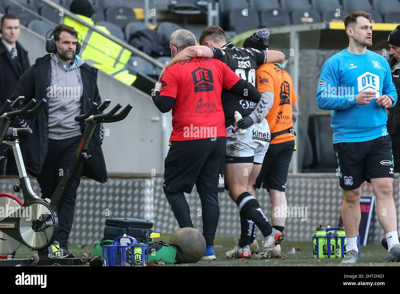 Cameron Scott #24 of Hull FC is helped off the pitch after getting an ...