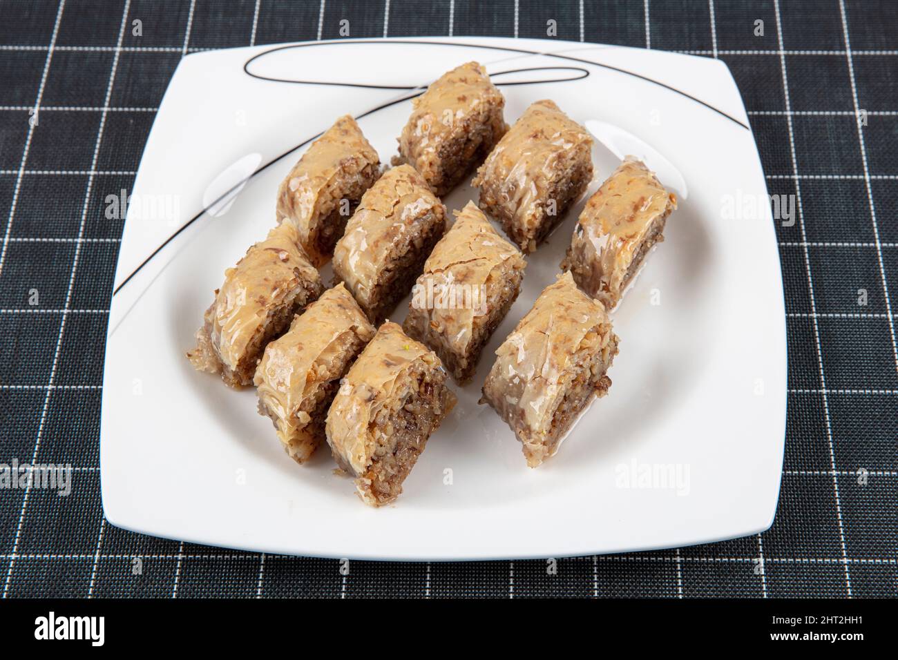 Traditional Turkish dessert walnut baklava with walnuts and tea on a ...