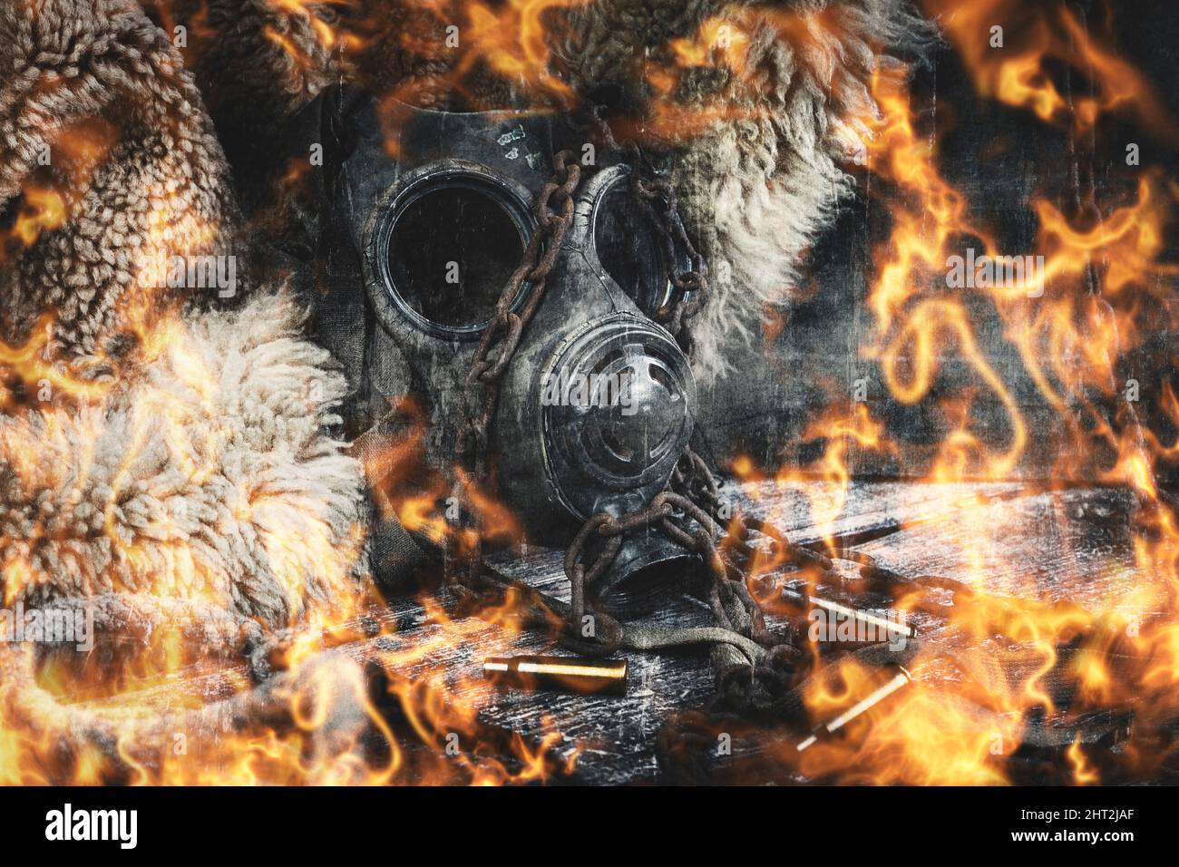 Military gas mask and rusty chain burning in flames. War and ...