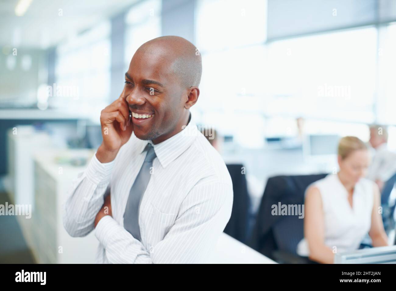 Catching up with his clientele. Positive young African executive on his ...