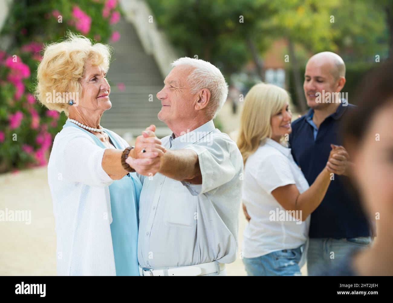 Two generation dancing in park Stock Photo - Alamy
