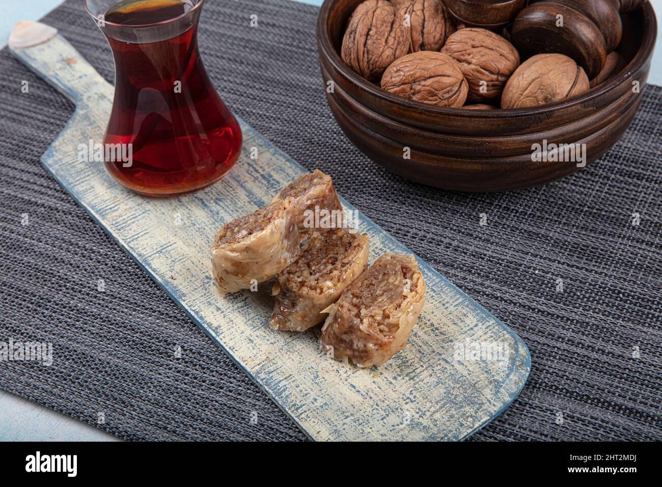 Traditional Turkish dessert walnut baklava with walnuts and tea on a ...