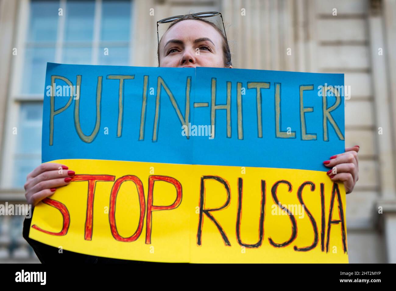 London, UK. 26 February 2022. A woman with a sign at a protest outside ...