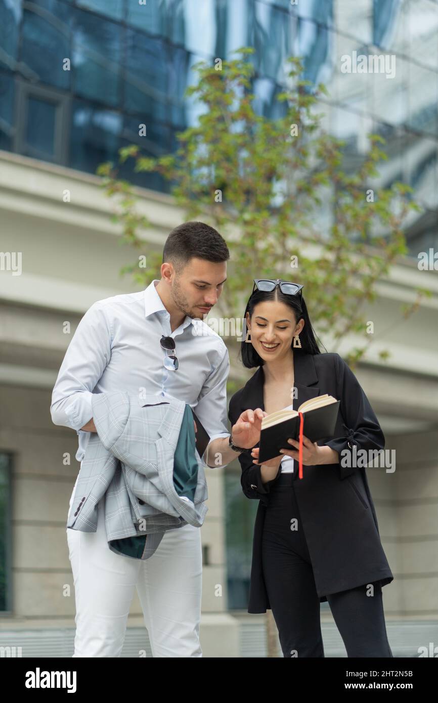 Two business people are smiling and talking about their company Stock ...