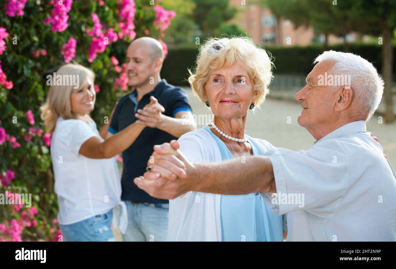Adult friends dancing pair dance in garden Stock Photo - Alamy