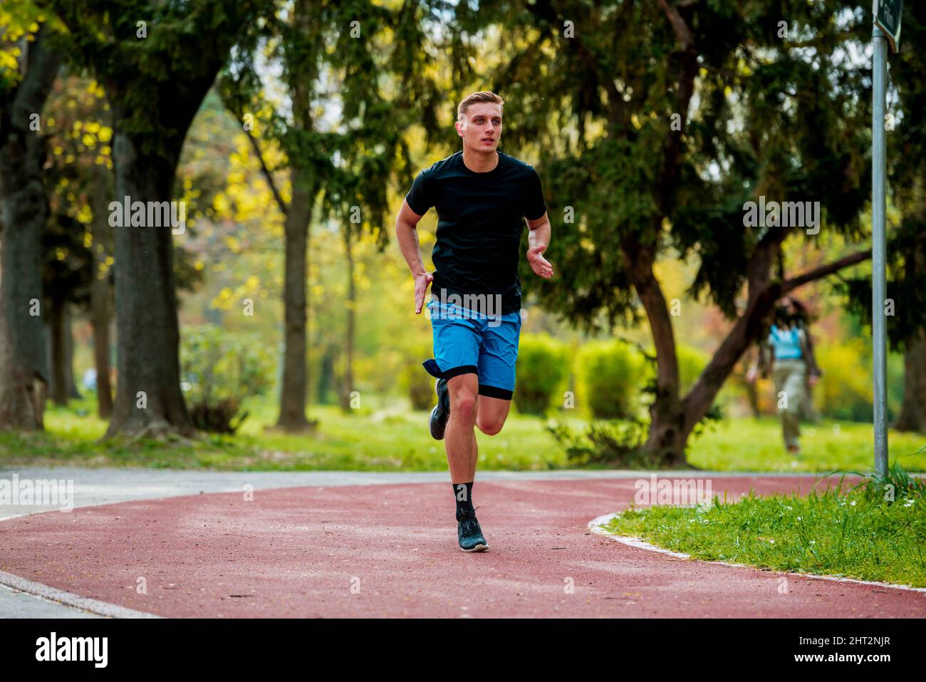Fitness running athlete jogging on athletics stadium track open air ...