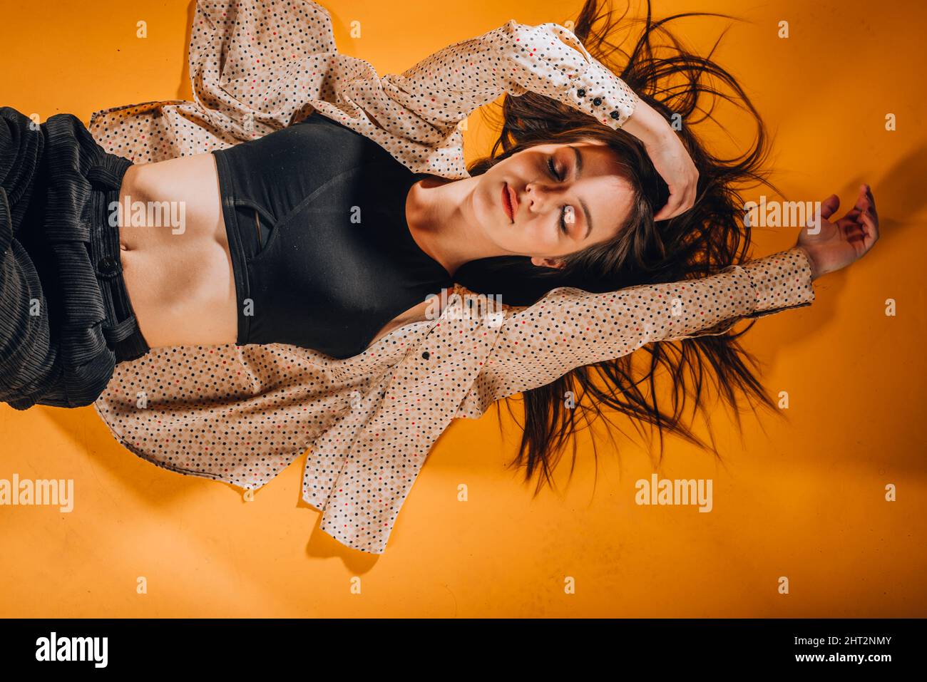 Dance moves performed by an acrobatic flexible female dancer lying on ...