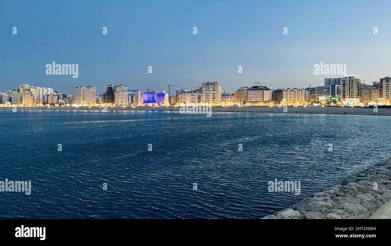 Beautiful view of the blue sea with the city in the background. Tanja ...