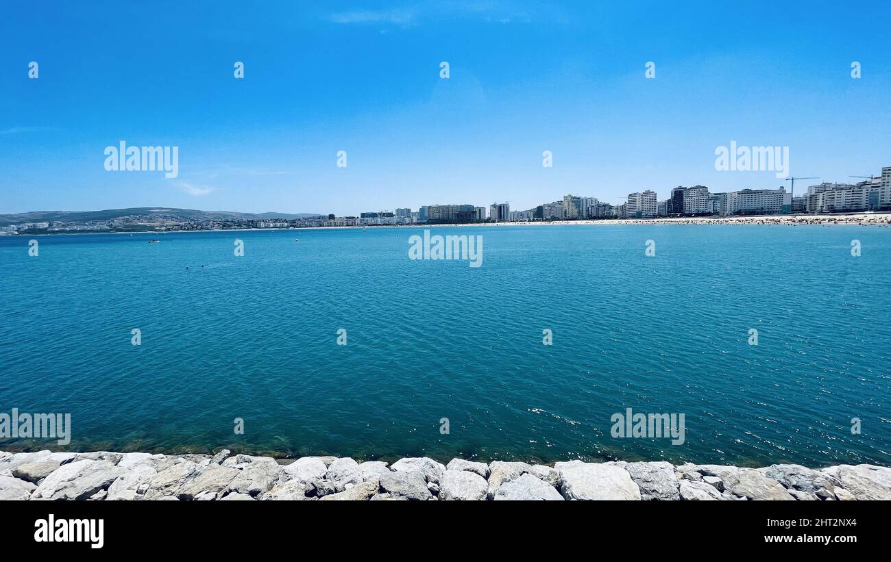 Beautiful view of the blue sea with the city in the background. Tanja ...