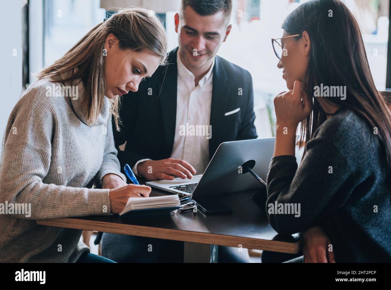 Work colleagues discussing new marketing strategies during a coffee ...