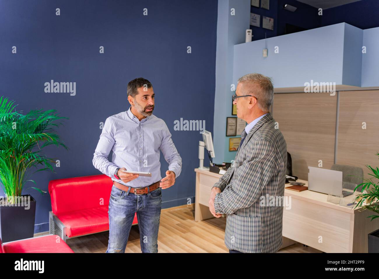 Two senior and handsome businessmen are talking to each other Stock ...