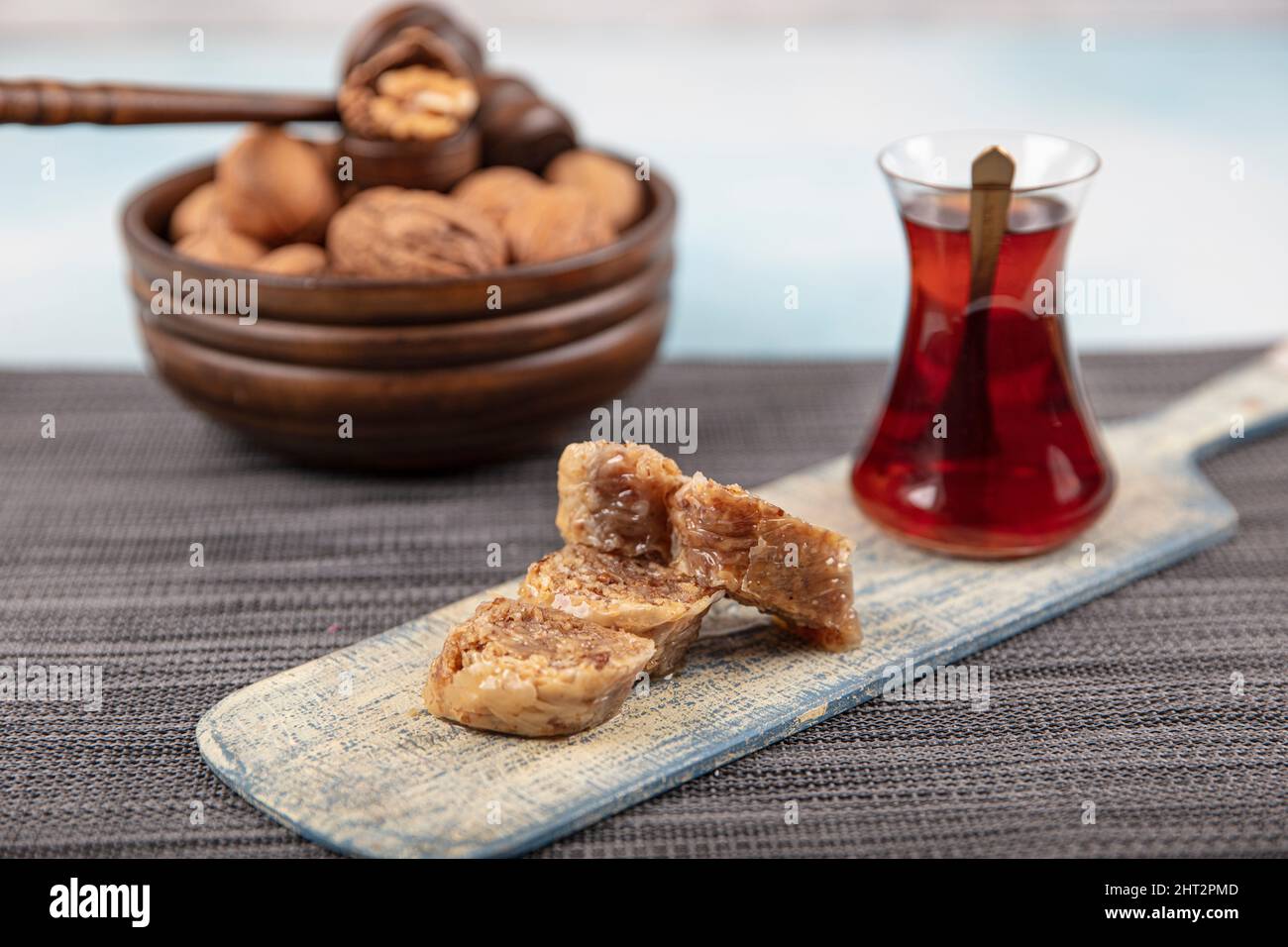 Traditional Turkish dessert walnut baklava with walnuts and tea on a ...