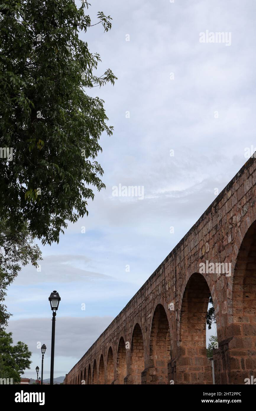 Vertical shot of a long building and street lamps Stock Photo - Alamy