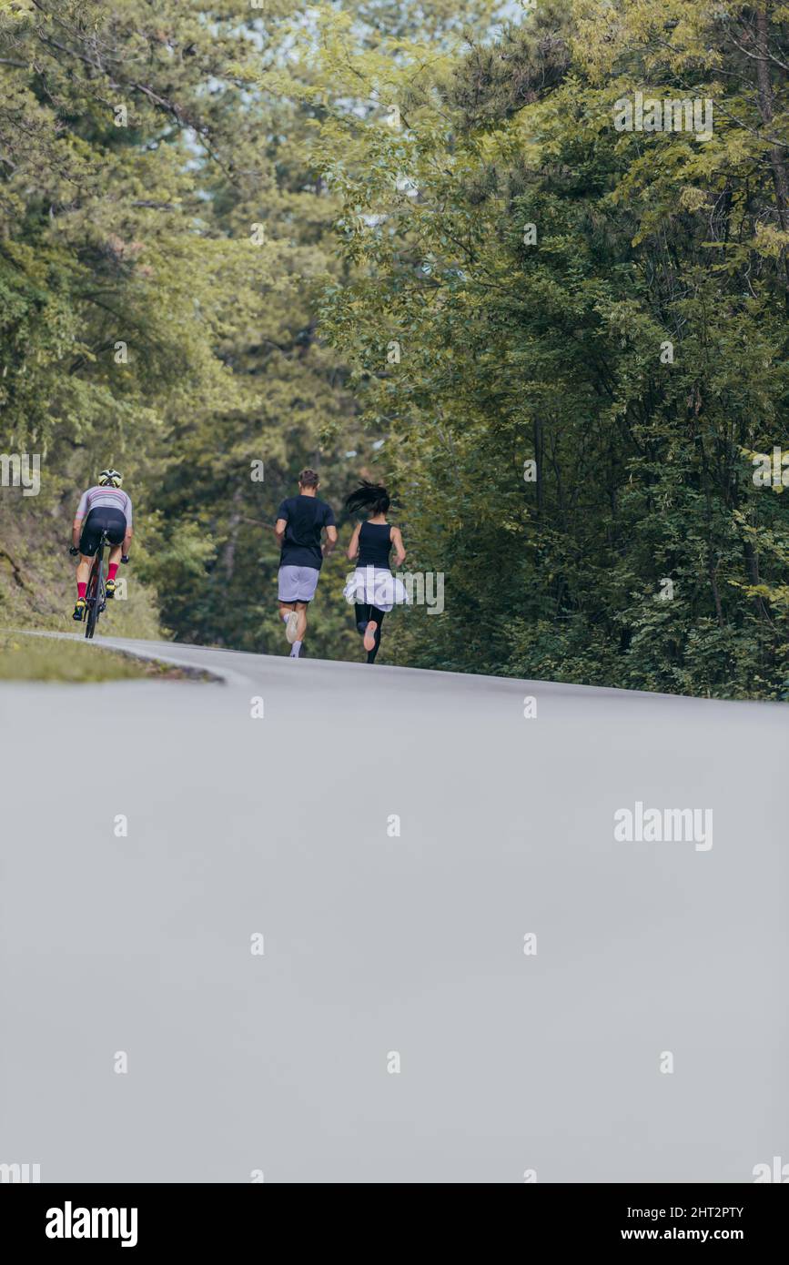 Athletic couple running on a street next to each other. Nature,fit and ...