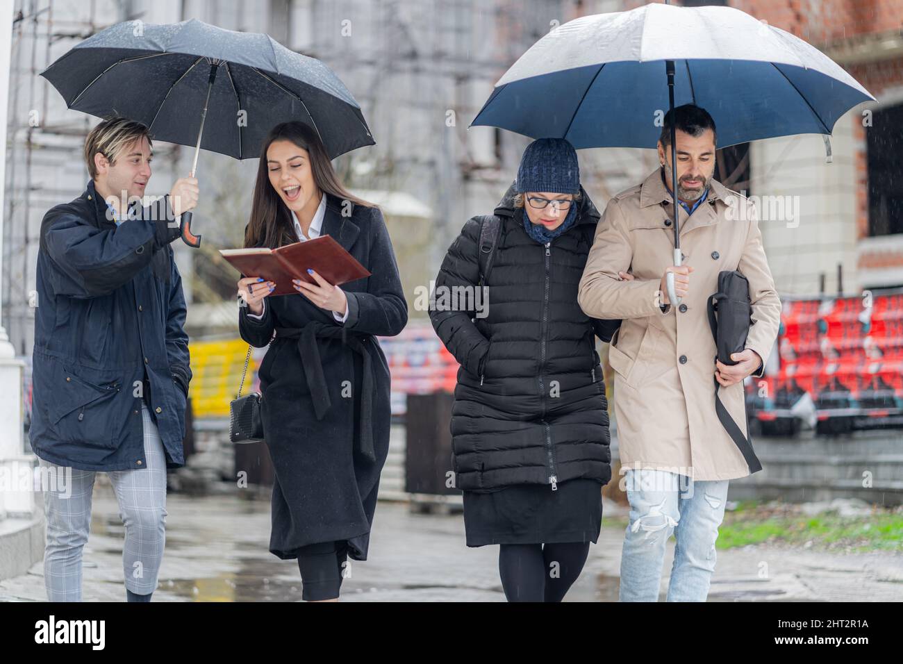 Four amazing and beautiful business people are talking and walking ...