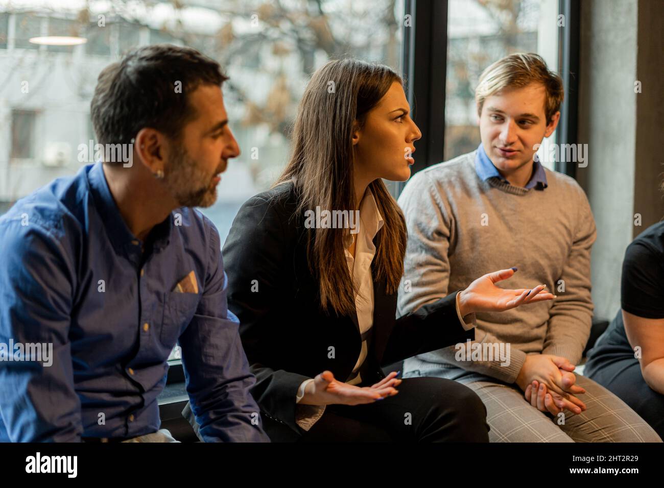 Group of amazing business people are having a serious talk in the cafe ...