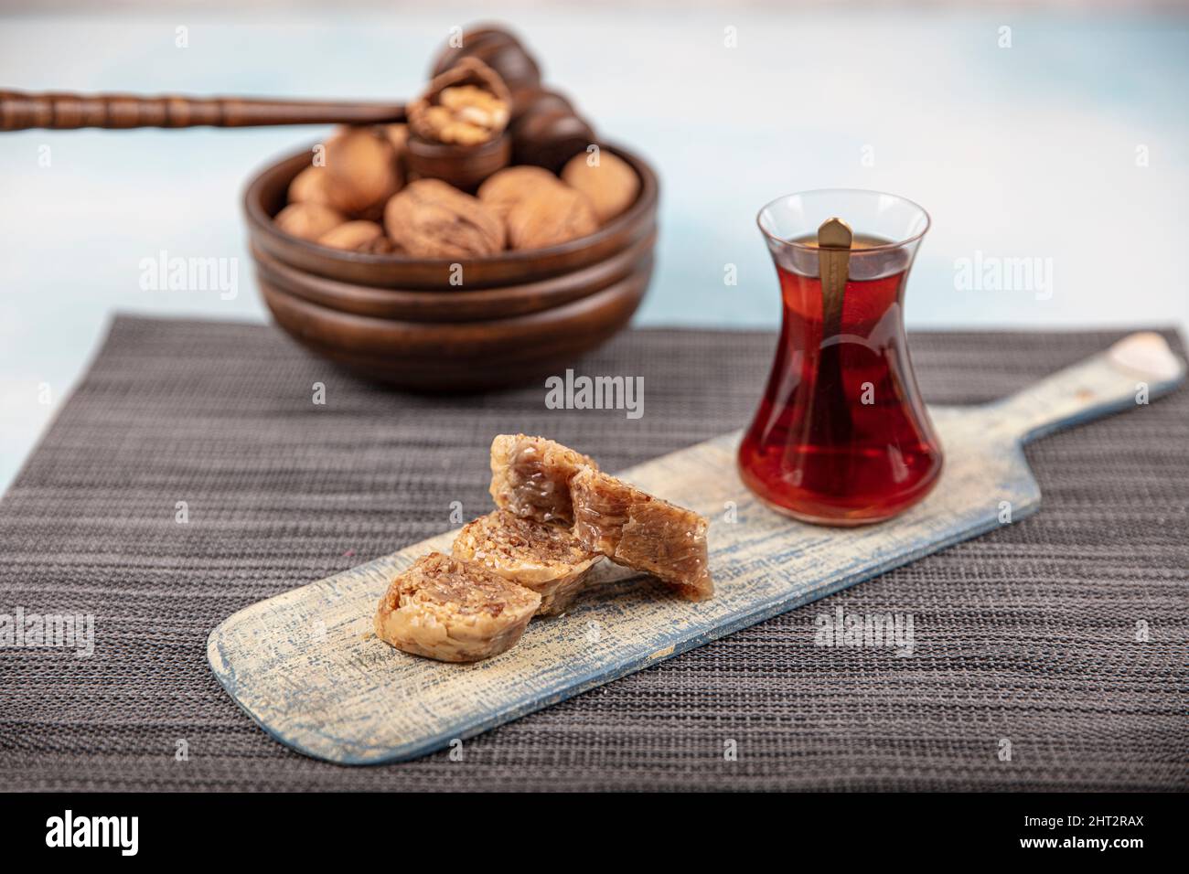 Traditional Turkish dessert walnut baklava with walnuts and tea on a ...