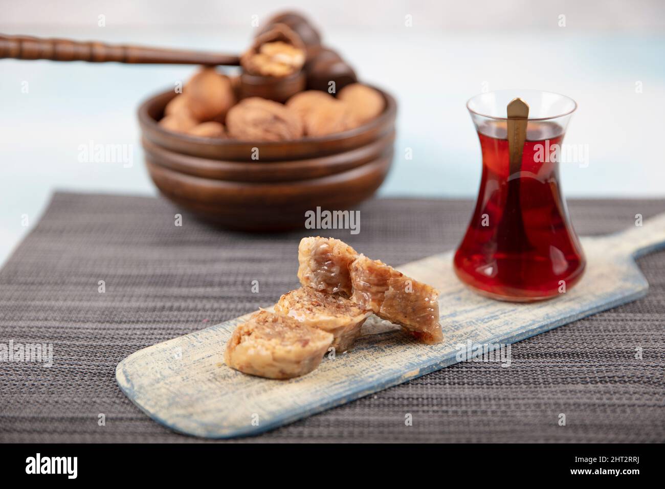 Traditional Turkish dessert walnut baklava with walnuts and tea on a ...