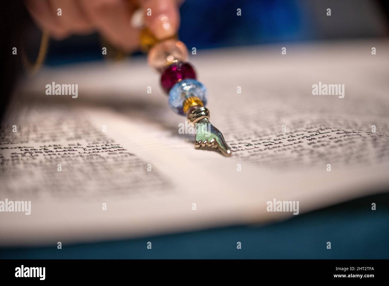 Person reading an ancient manuscript with the help of a vintage ...