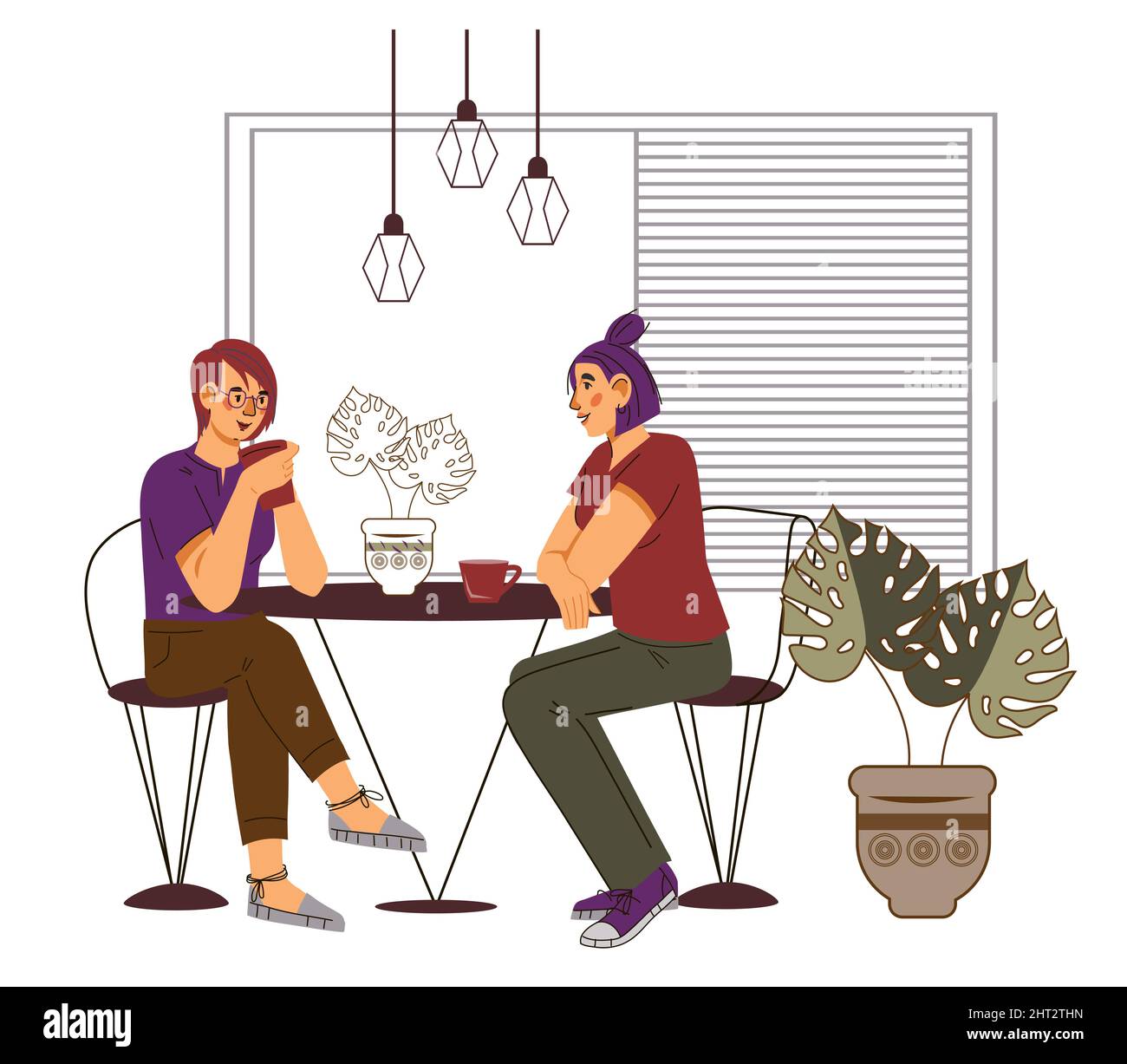 Two girlfriends chatting at a table in a restaurant or coffee shop ...