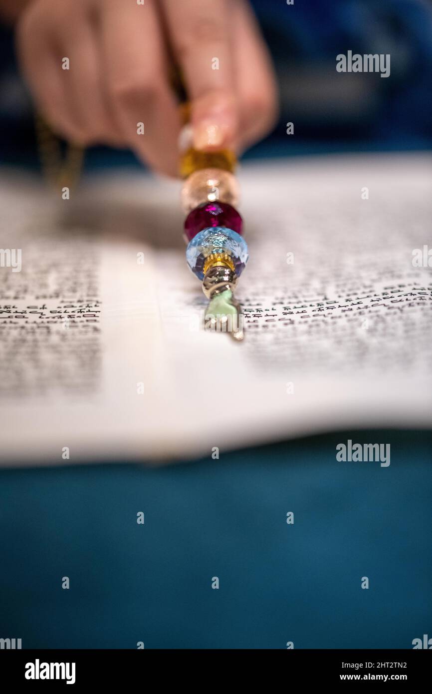Person reading an ancient manuscript with the help of a vintage ...