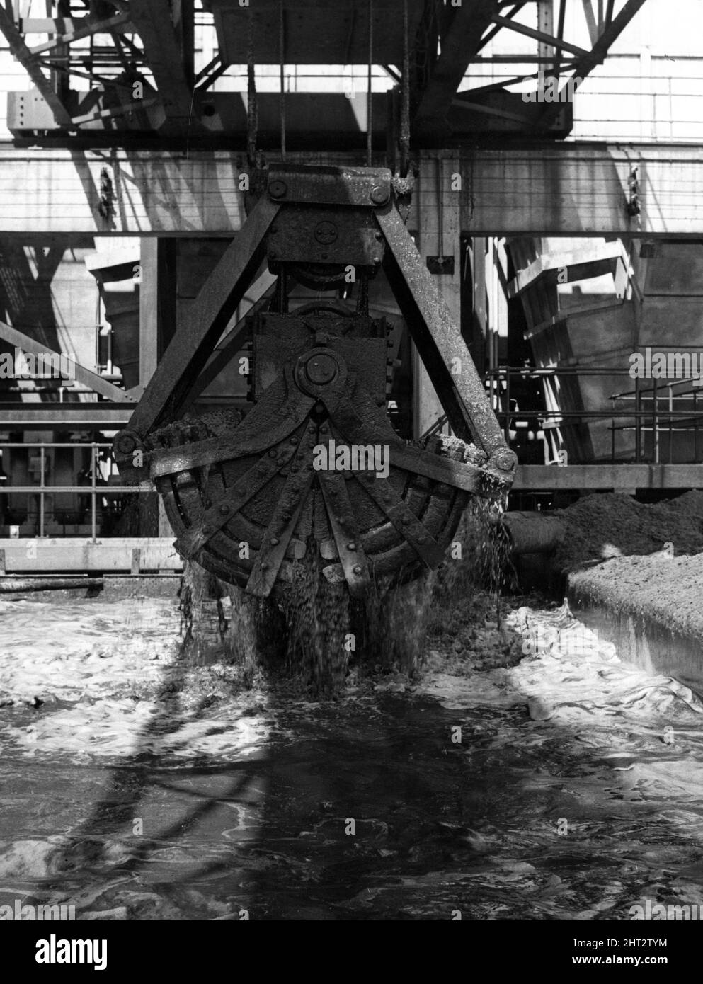 The grab crane, rises out of the ash settling tank, drawing off the ash ...
