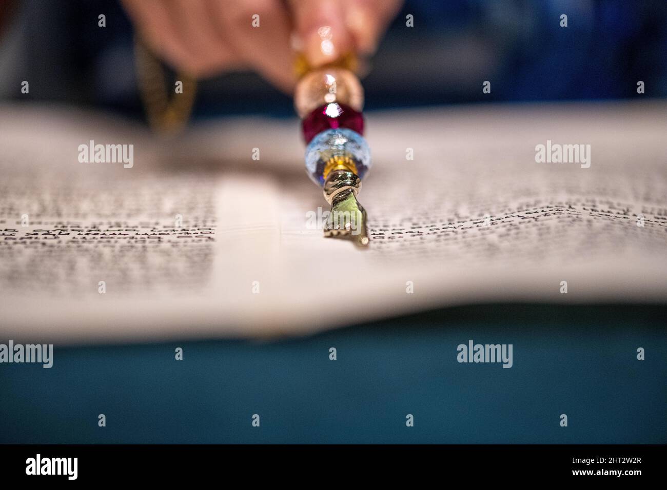 Person reading an ancient manuscript with the help of a vintage ...