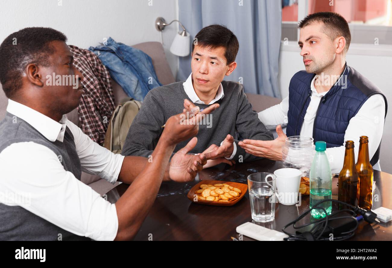 Three men are drinking beer and arguing in time rest together Stock ...