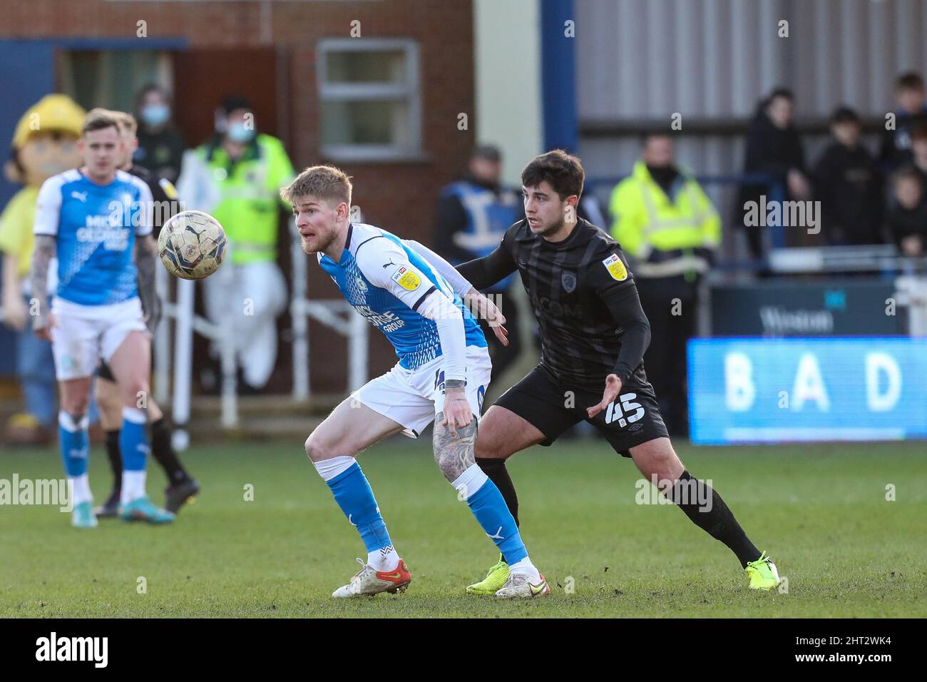 Hayden Coulson #43 of Peterborough United shields the ball from Liam ...