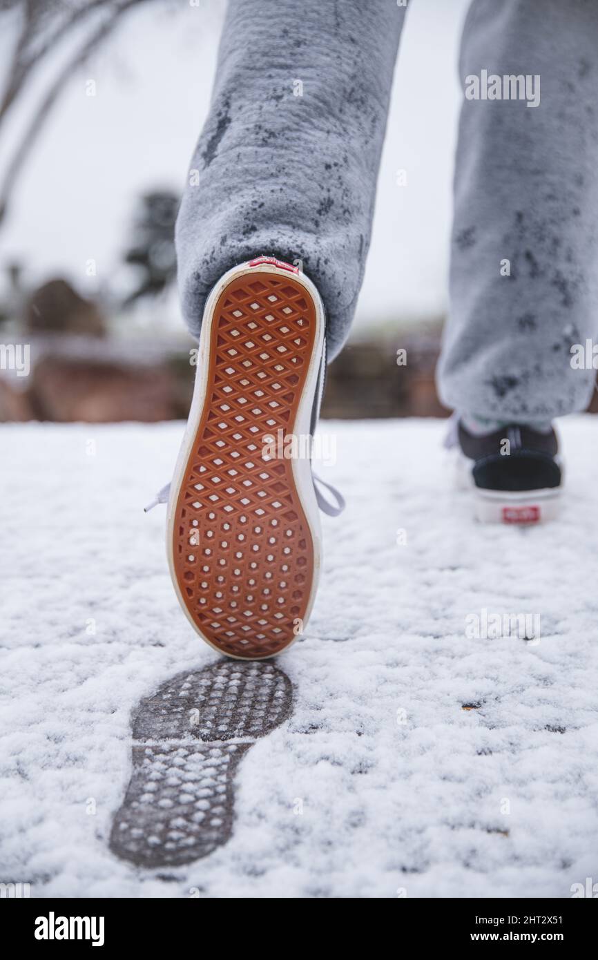 Photo of a person walking and leaving a foot print in the snow Stock ...